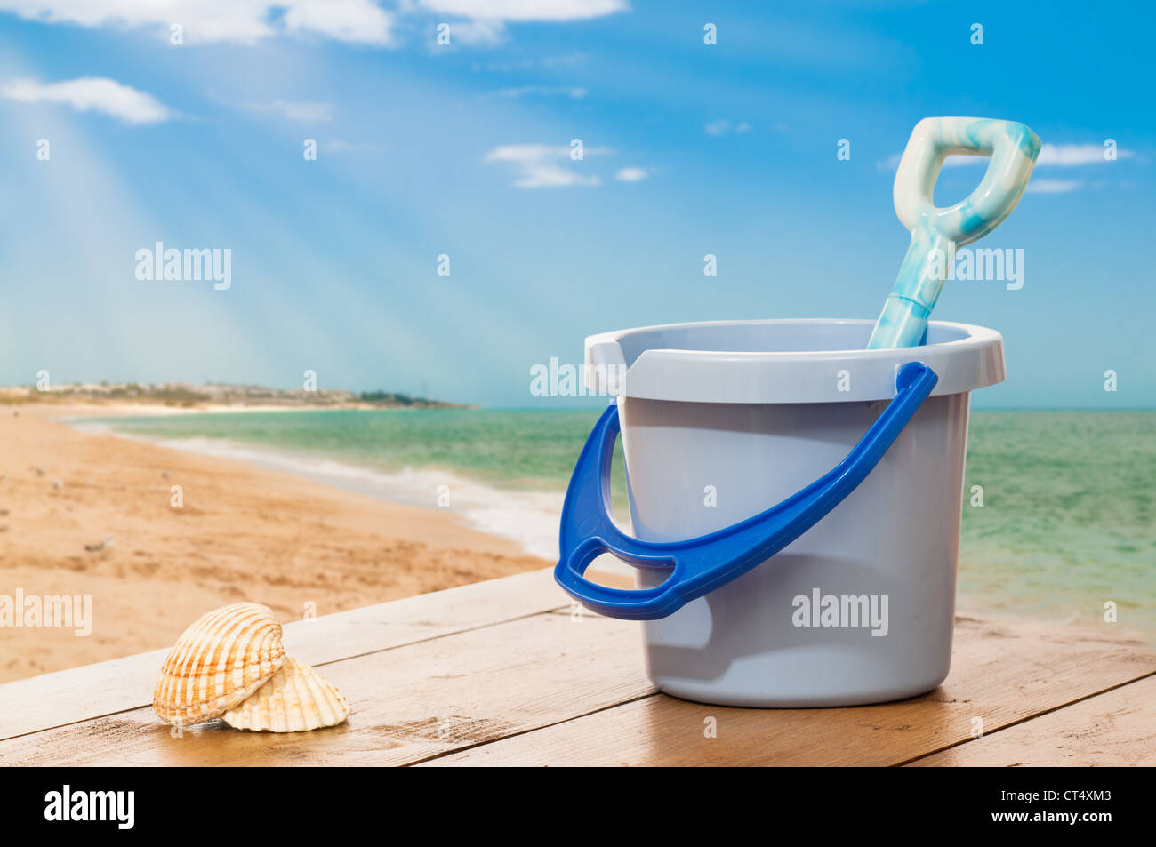 Holiday concept with bucket and spade against summer beach background ...