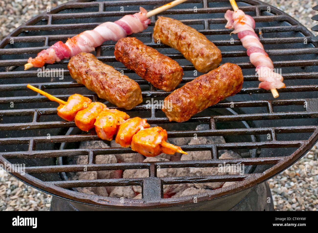 Croatian deli cevapi on barbecue Stock Photo - Alamy