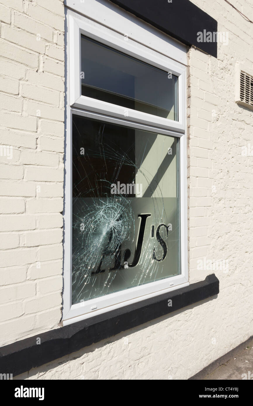Shattered window at AJ's cafe in Albert Road, Farnworth Stock Photo - Alamy