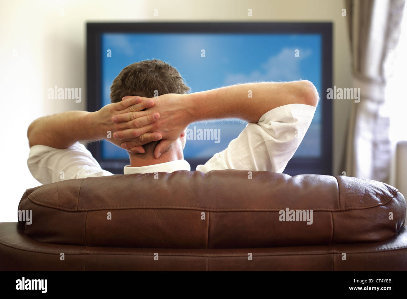 Back view young man watching hi-res stock photography and images - Alamy