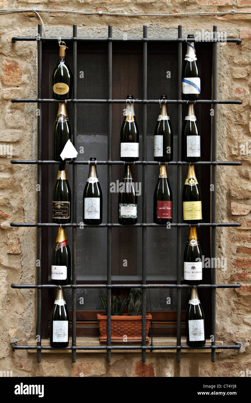 Empty wine bottle used as decoration in a window frame, Bibbona Tuscany ...