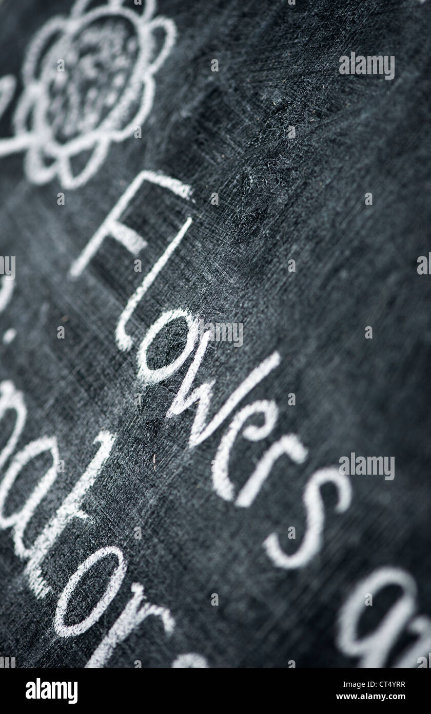 The word flowers written on a garden blackboard Stock Photo - Alamy