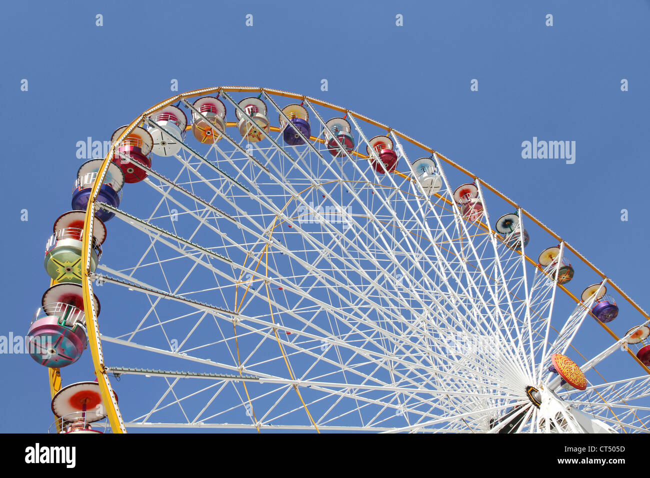 Ferris wheel in an amusement park against blue sky Stock Photo - Alamy