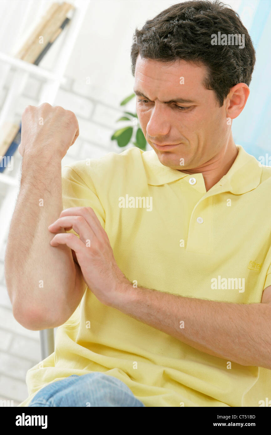ITCHING IN A MAN Stock Photo - Alamy
