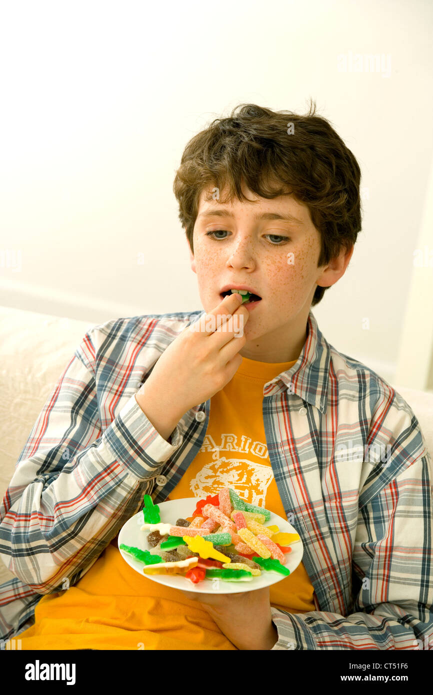 CHILD EATING SWEETS Stock Photo - Alamy