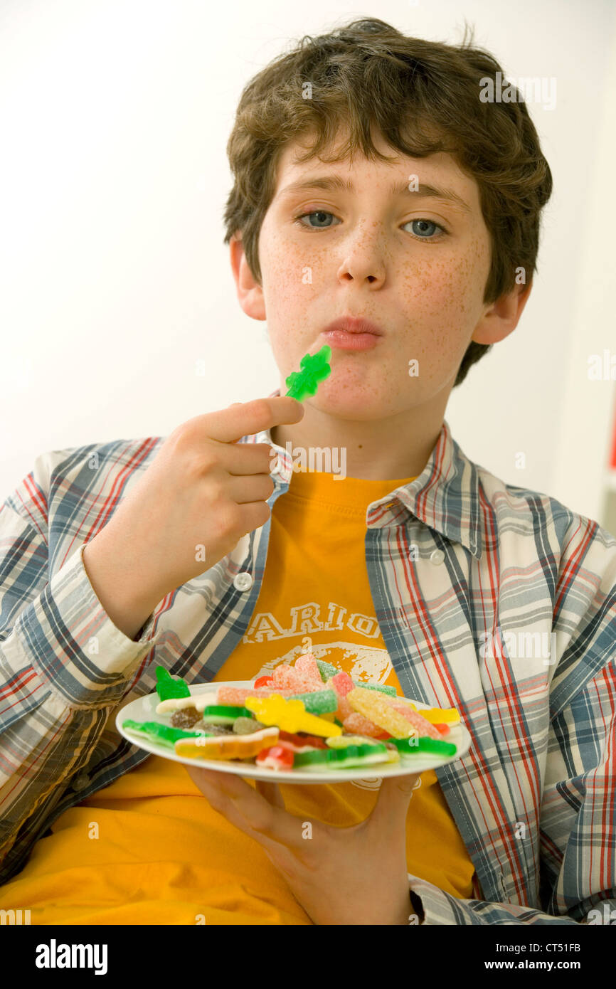 CHILD EATING SWEETS Stock Photo - Alamy