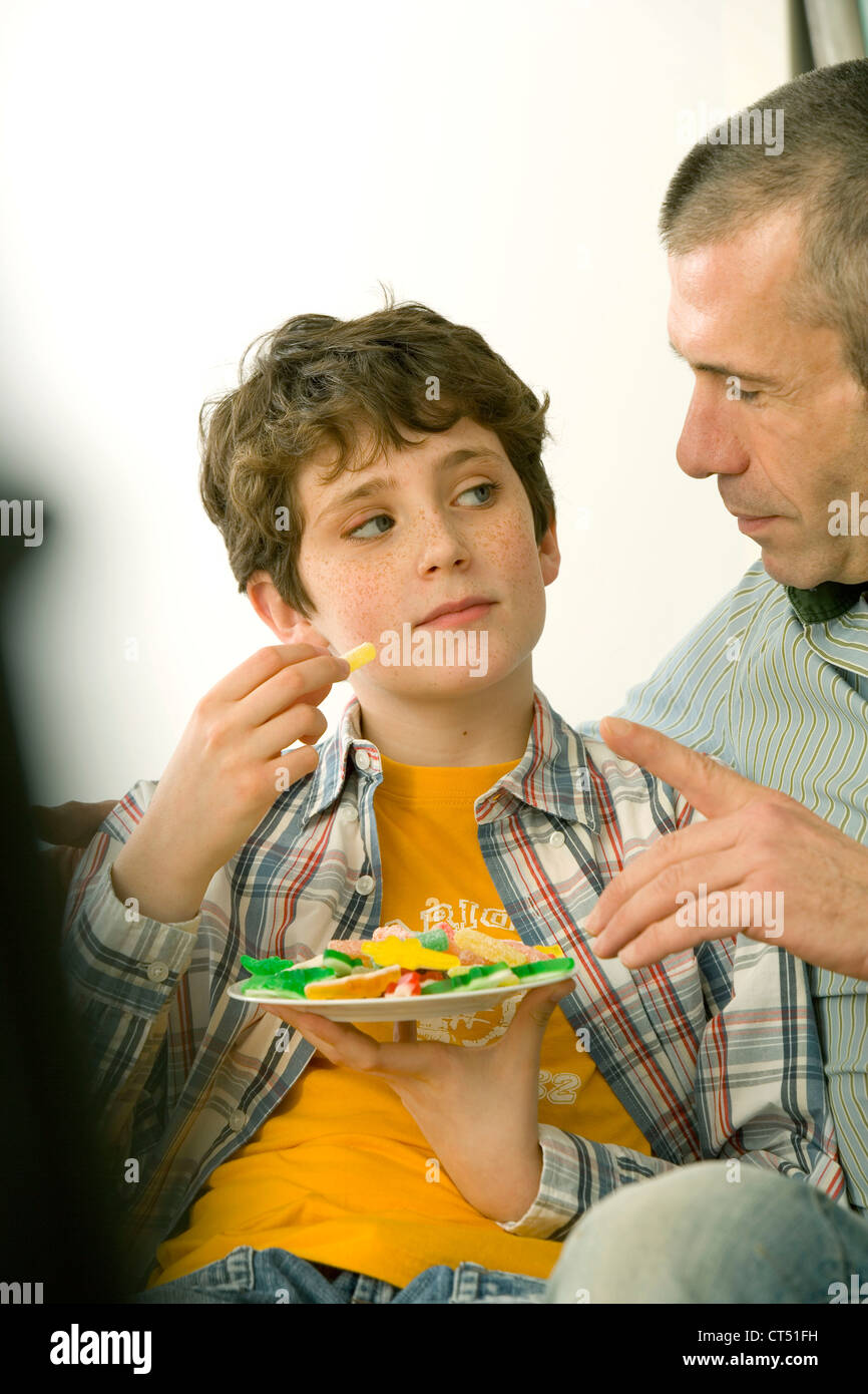 CHILD EATING SWEETS Stock Photo - Alamy