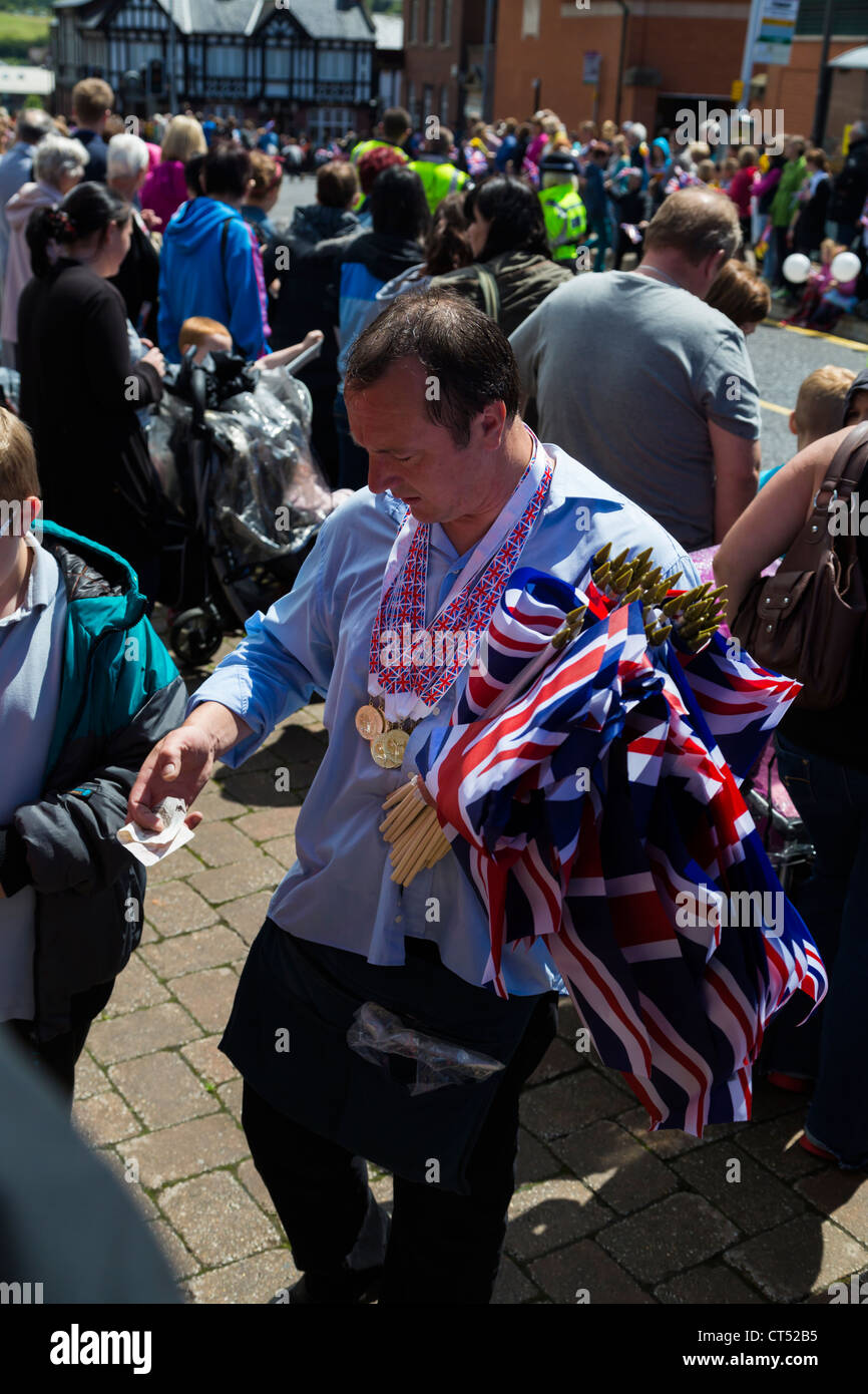 Street vendor selling Olympic games souvenirs during Torch relay ...