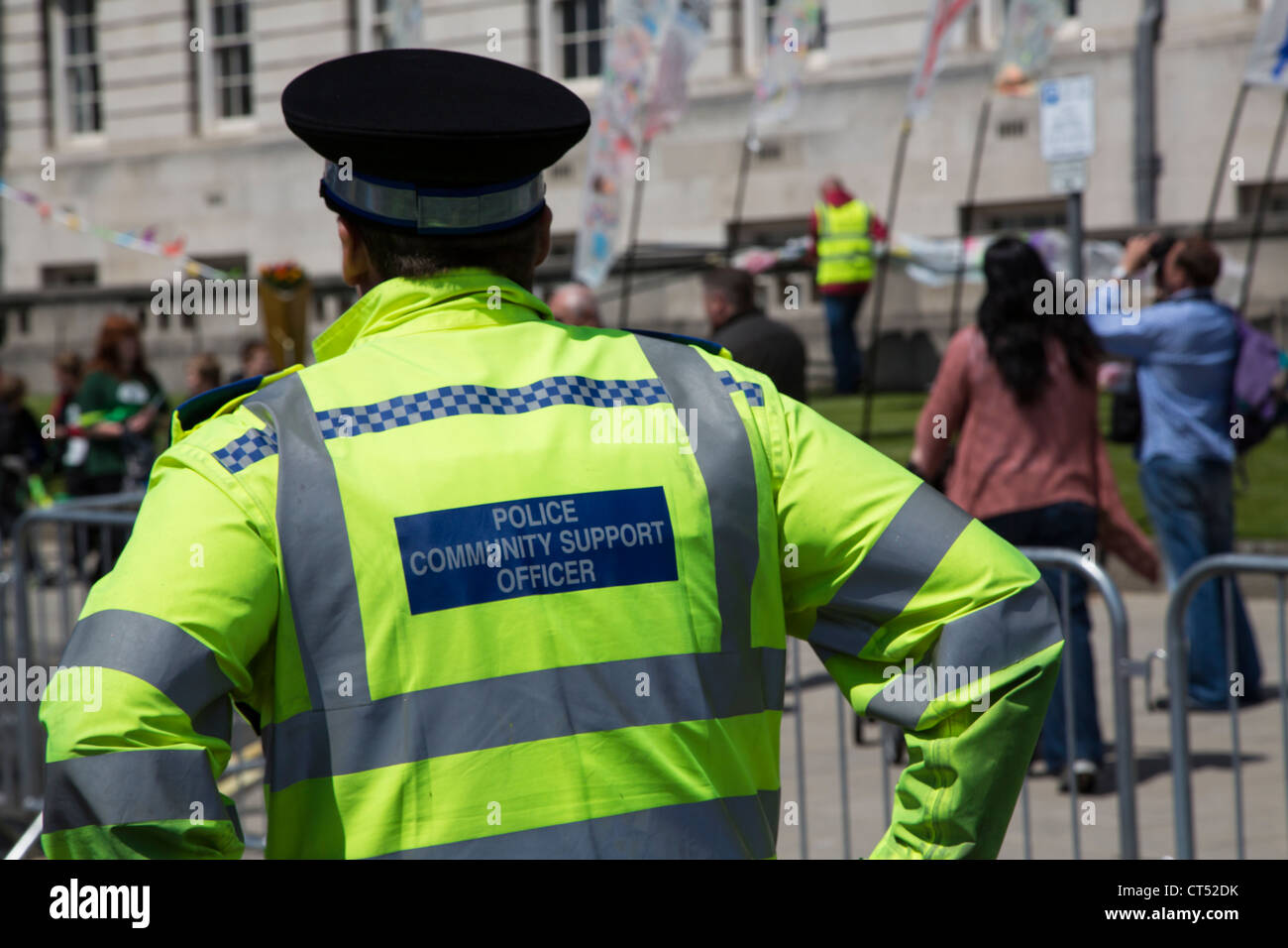 Police Community support officer watching the Olympic Torch relay ...