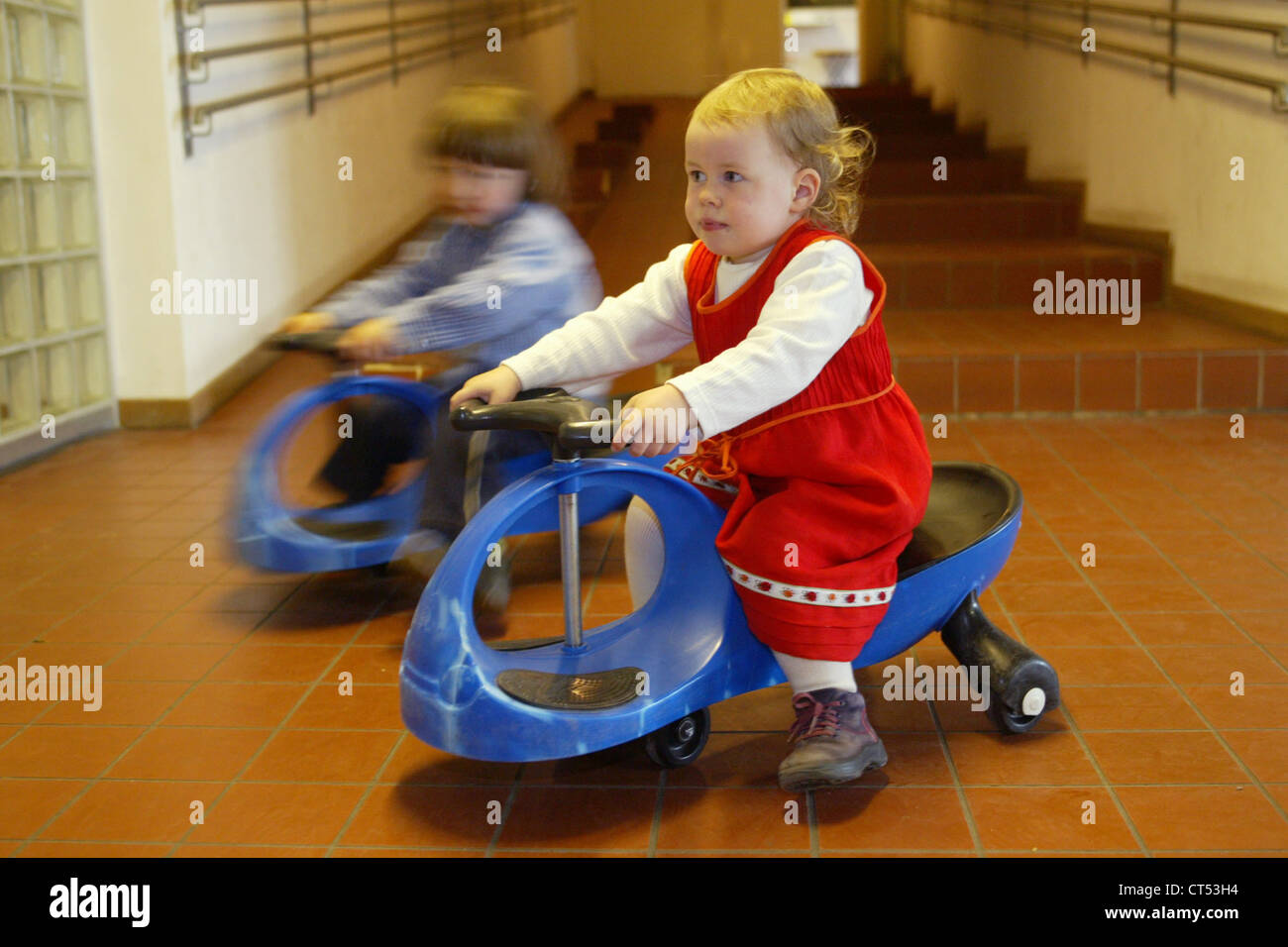 Berlin, children ride their toy cars Stock Photo - Alamy