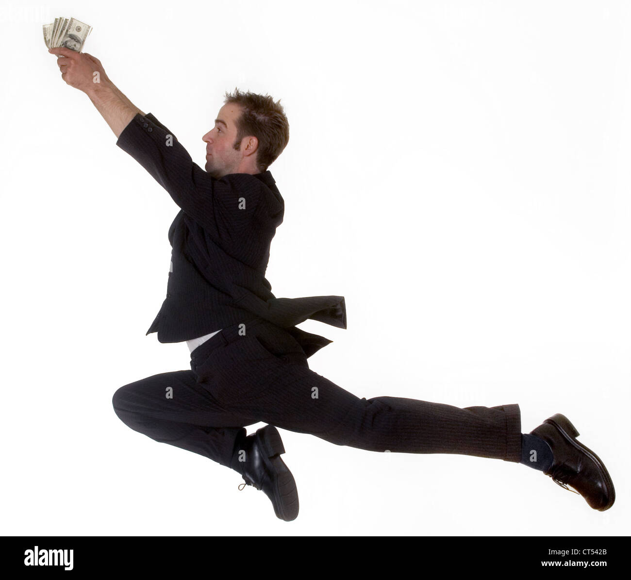 A man jumps with money in hand Stock Photo - Alamy