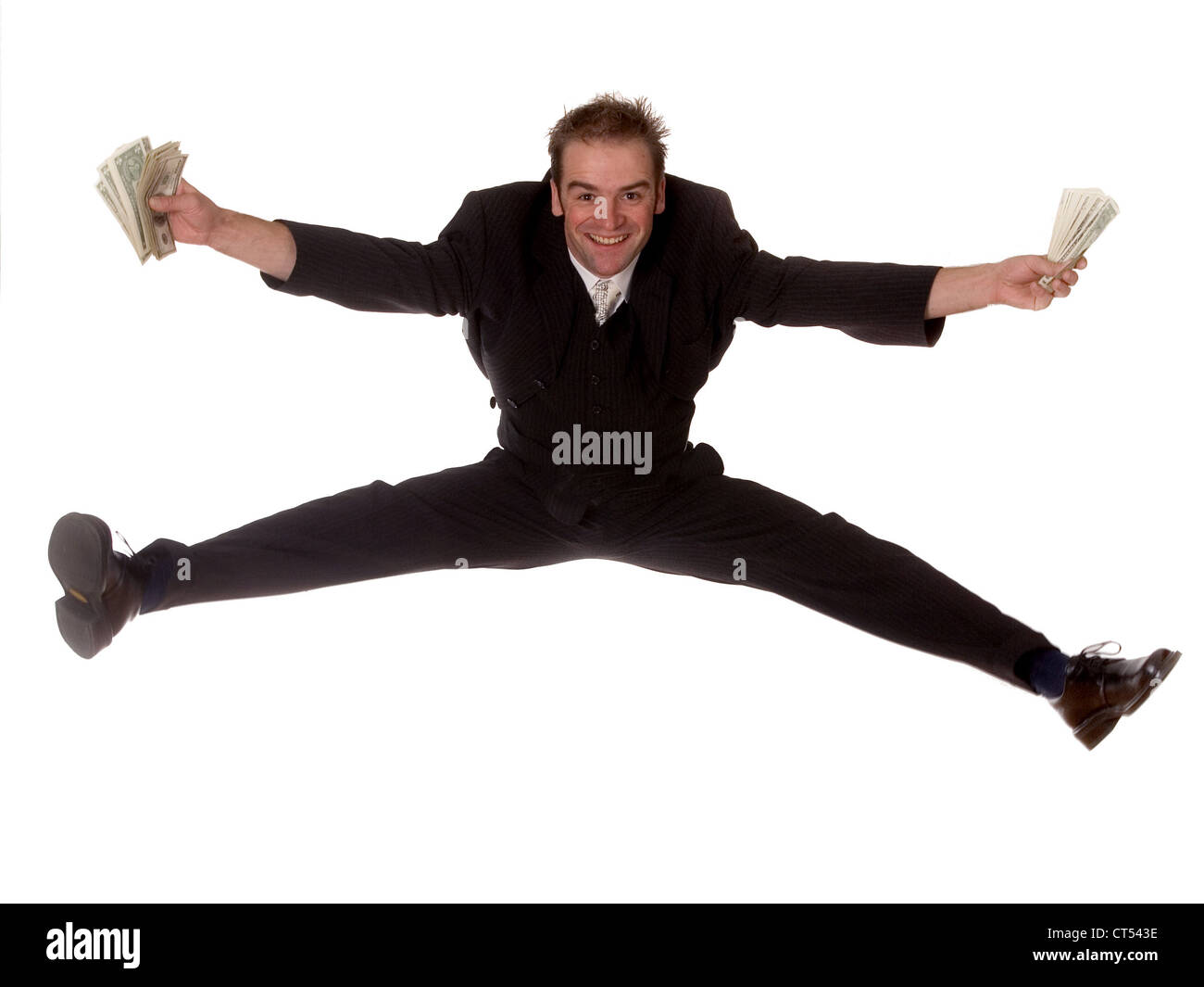 A man jumps with money in hand Stock Photo - Alamy