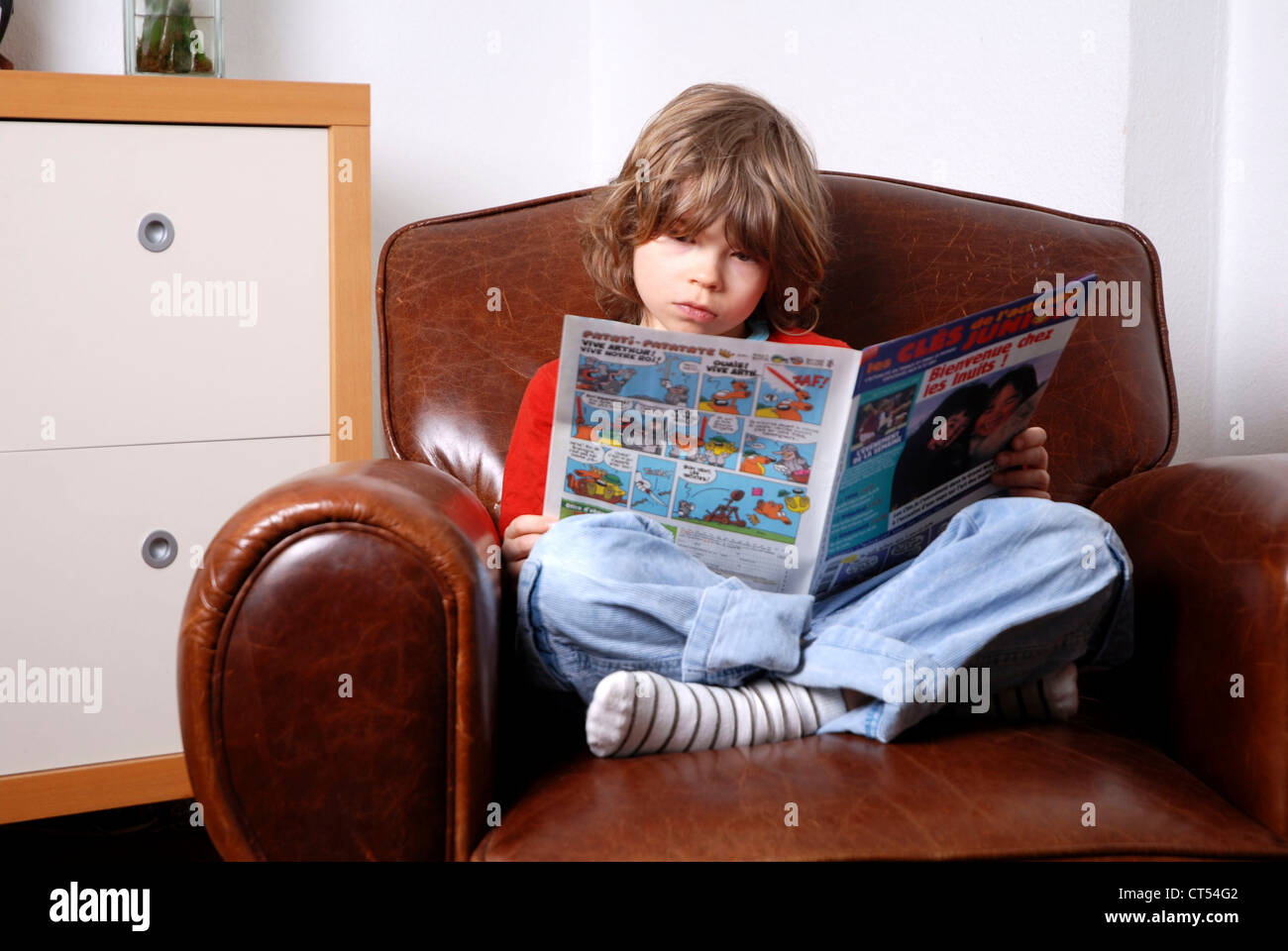 CHILD READING INDOORS Stock Photo - Alamy