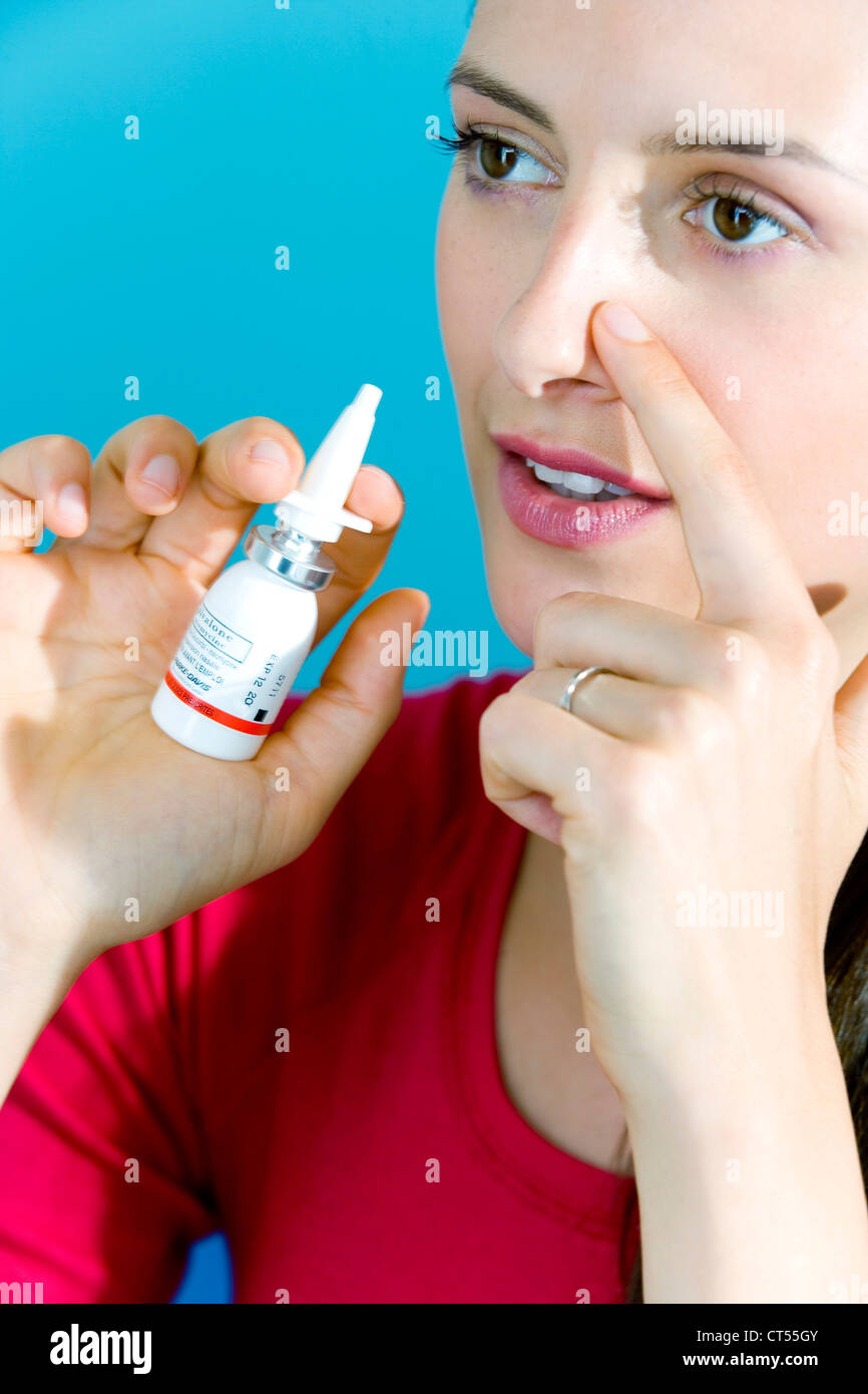 WOMAN USING NOSE SPRAY Stock Photo - Alamy