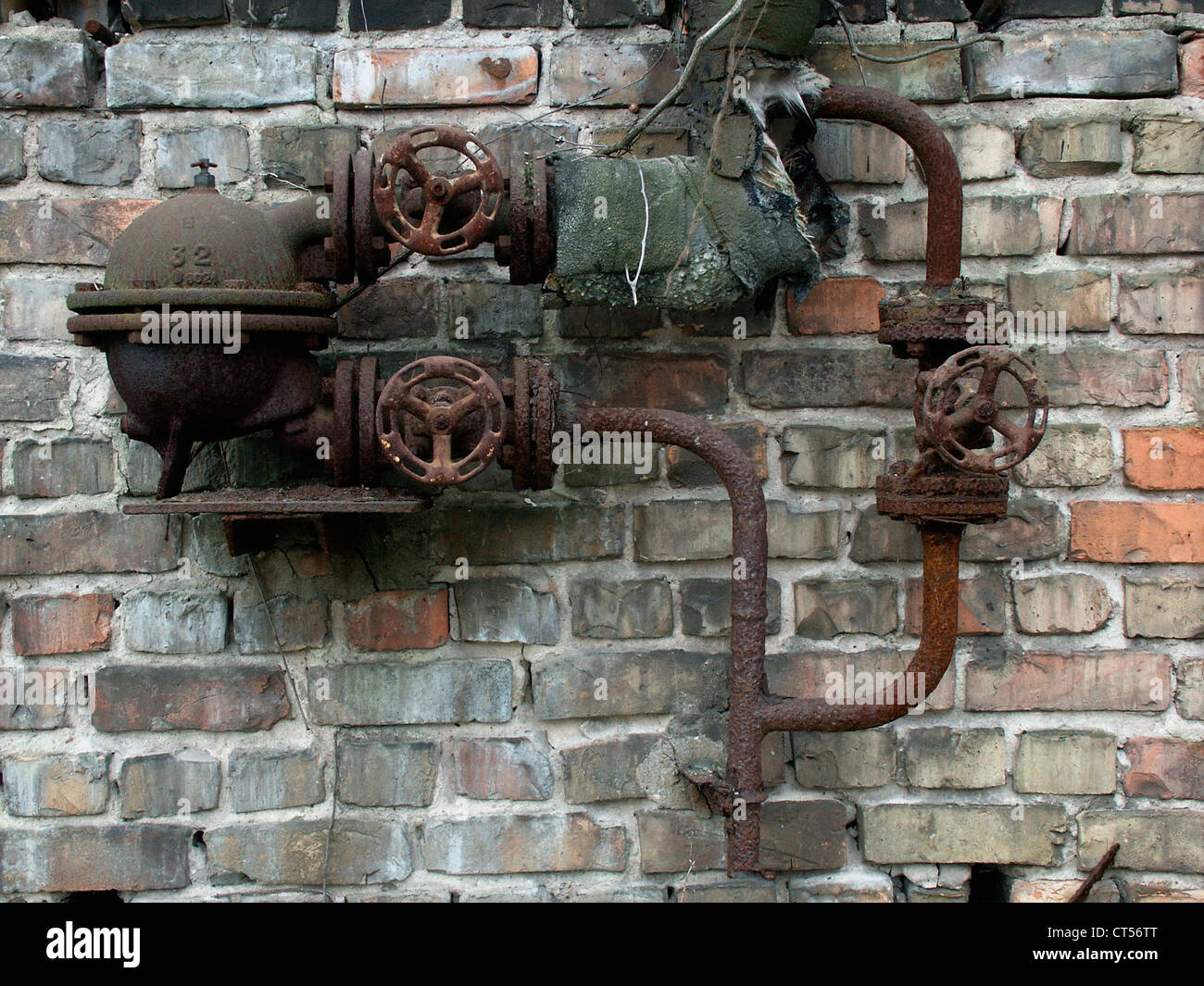 Berlin, rusted pipe installation on brick wall Stock Photo - Alamy
