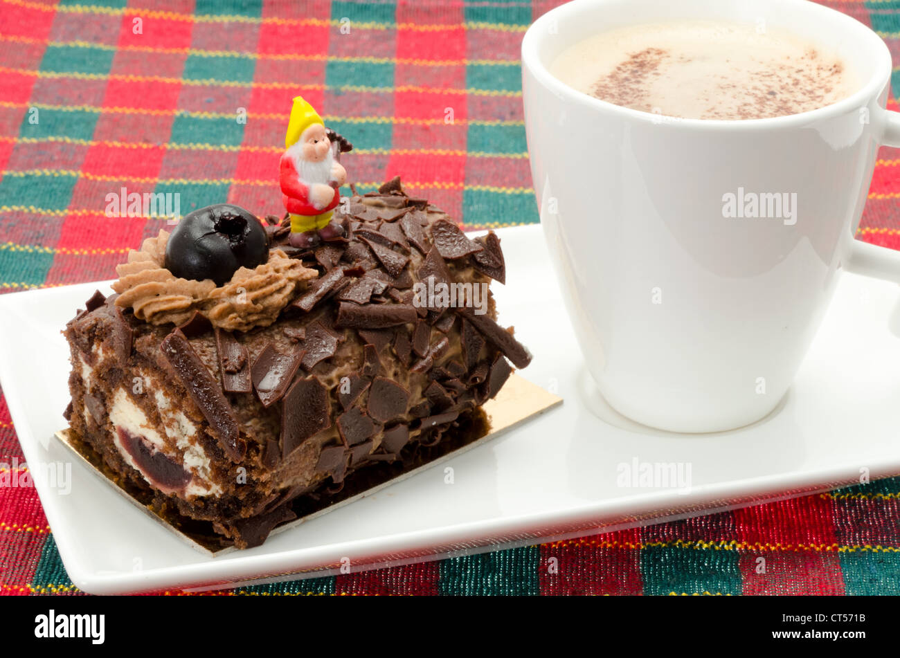 Buchette de Noel with a white coffee. The classic Buche de Noel is the ...
