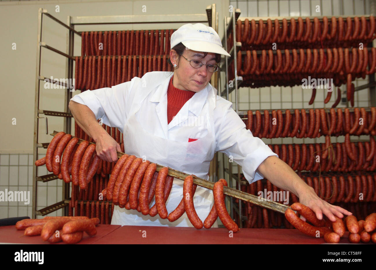 Fleischerin in sausage production Stock Photo - Alamy