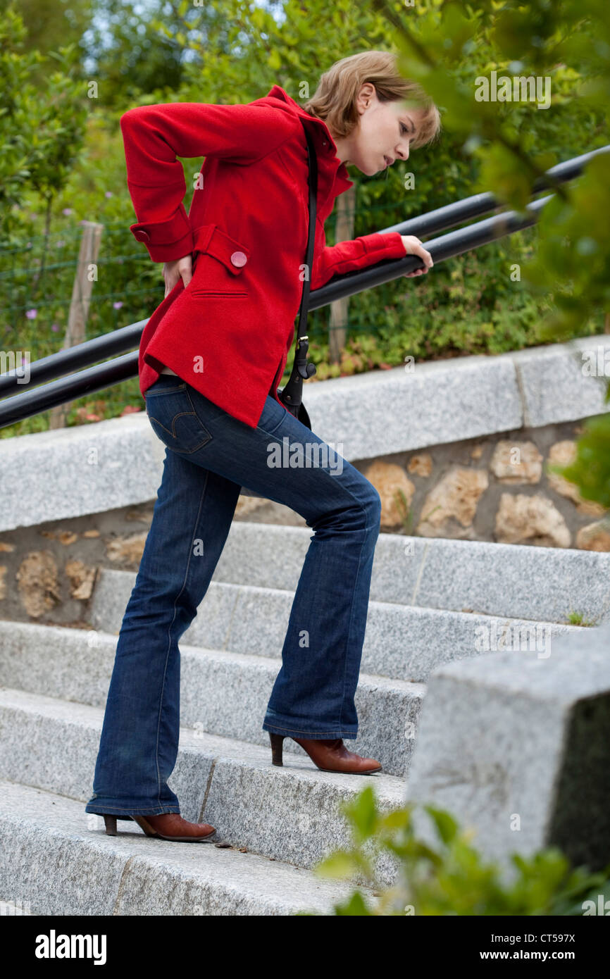 LOWER BACK PAIN IN A WOMAN Stock Photo - Alamy