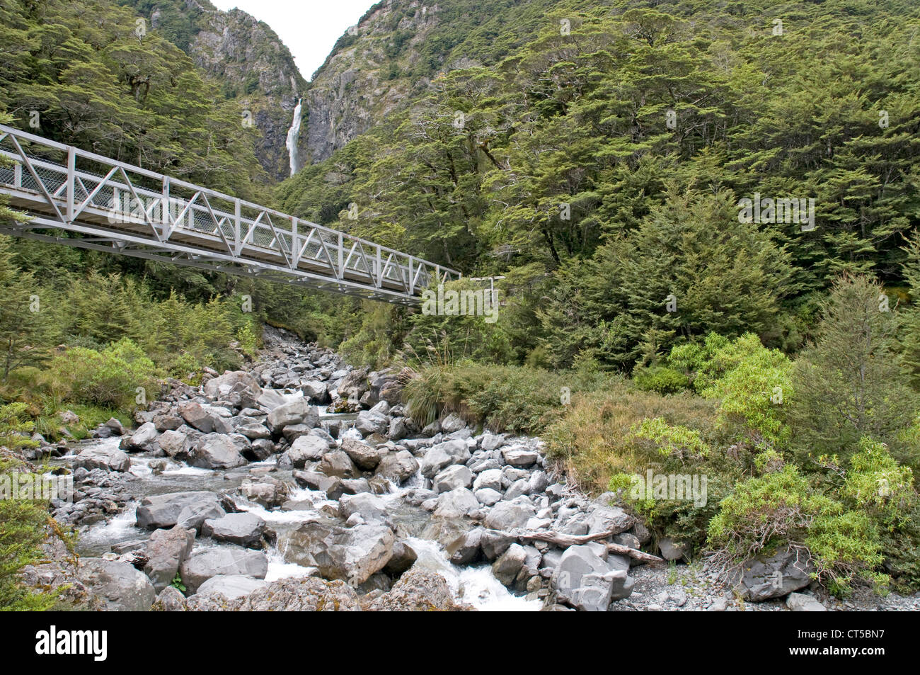 Walkway over a stream in Arthur's Pass, with the Devil's Punchbowl ...