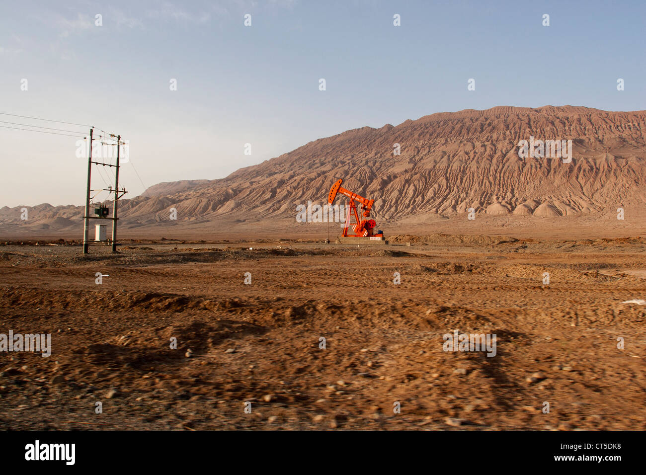 A nodding donkey pump jack, or pumping unit is seen in the desert with ...