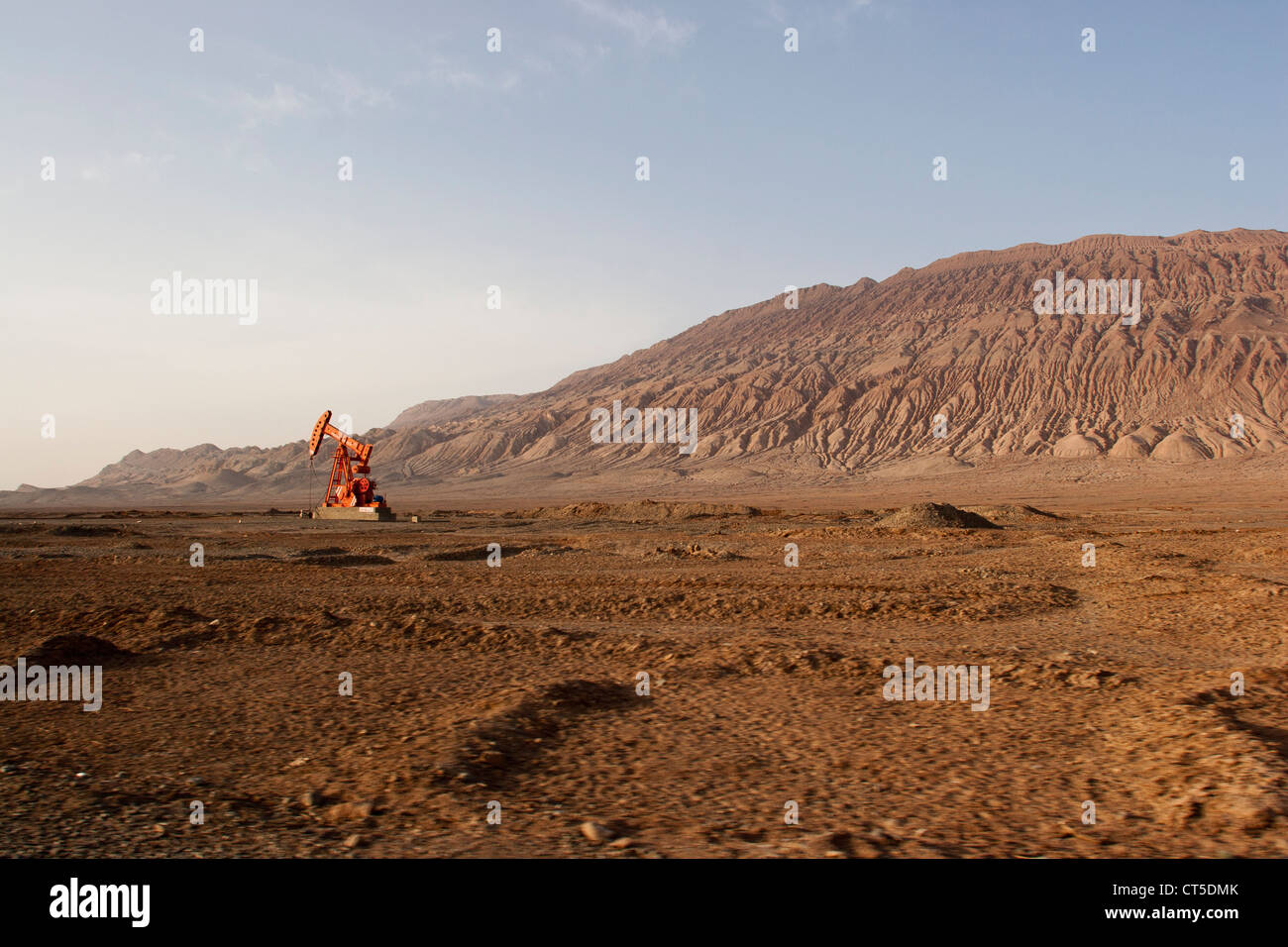 A nodding donkey pump jack, or pumping unit is seen in the desert with ...