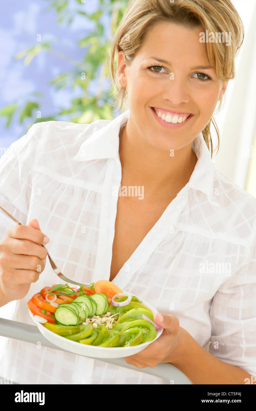 WOMAN EATING RAW VEGETABLES Stock Photo - Alamy