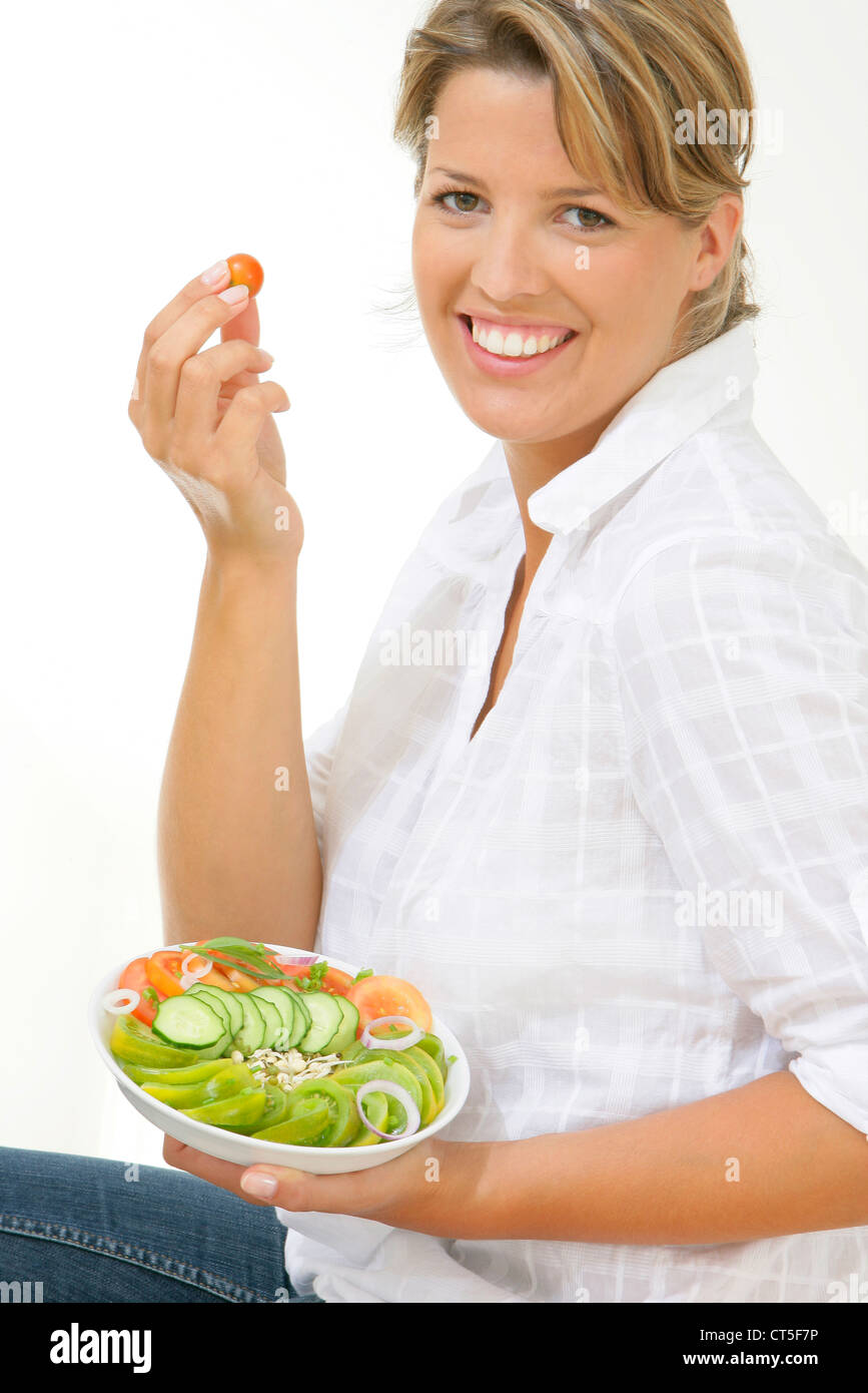 WOMAN EATING RAW VEGETABLES Stock Photo - Alamy