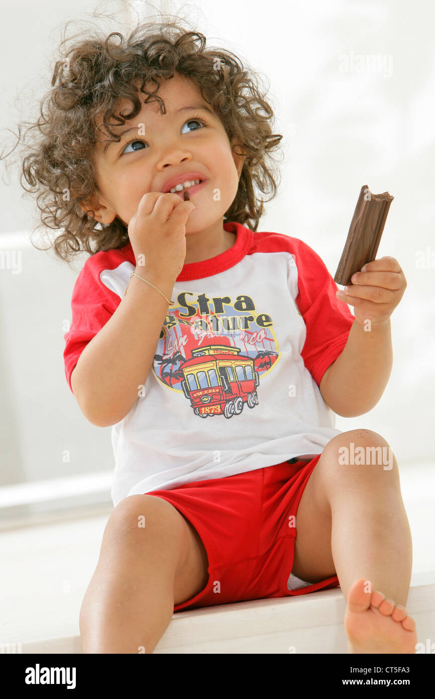 CHILD EATING SWEETS Stock Photo - Alamy