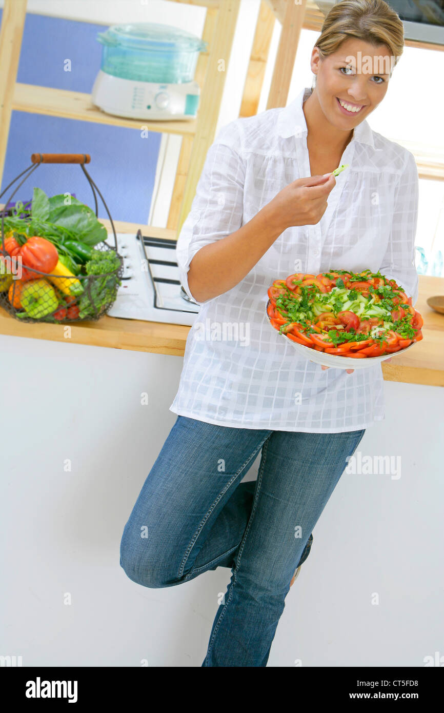 WOMAN EATING RAW VEGETABLES Stock Photo - Alamy