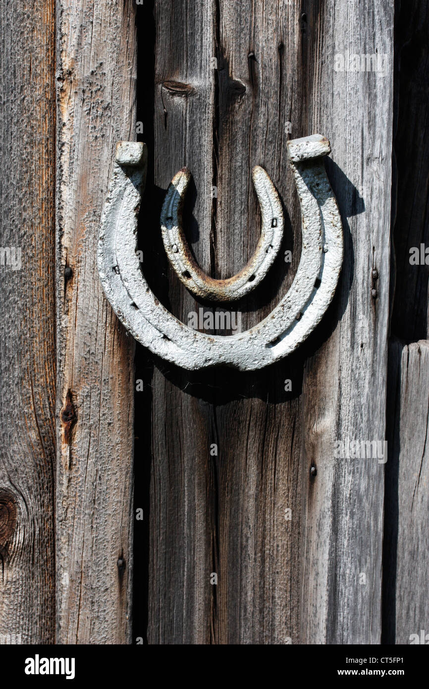 Two horseshoes on a wooden barn door Stock Photo - Alamy