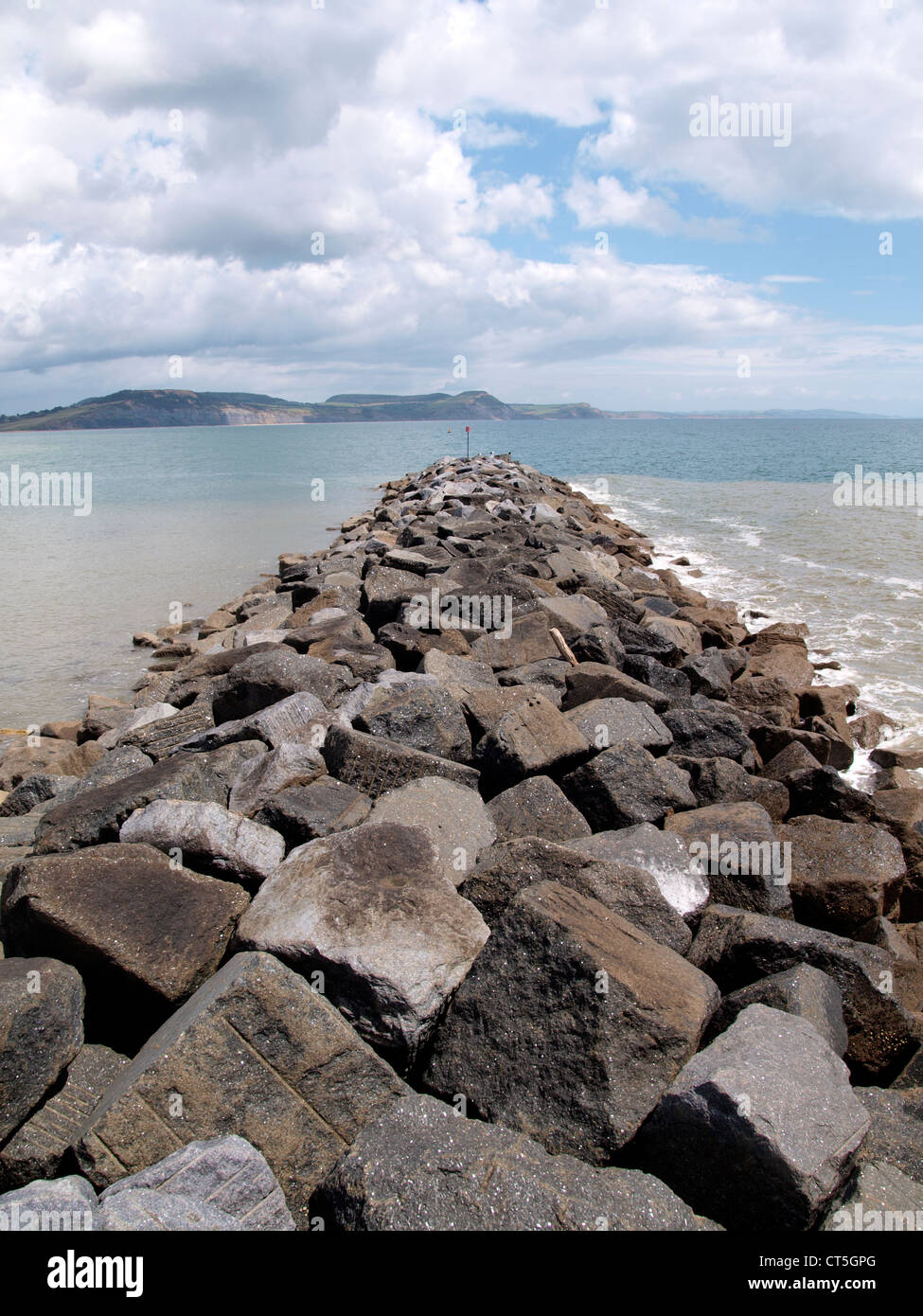 Pile of rocks forming a breakwater at the end of Lyme Regis Harbour ...