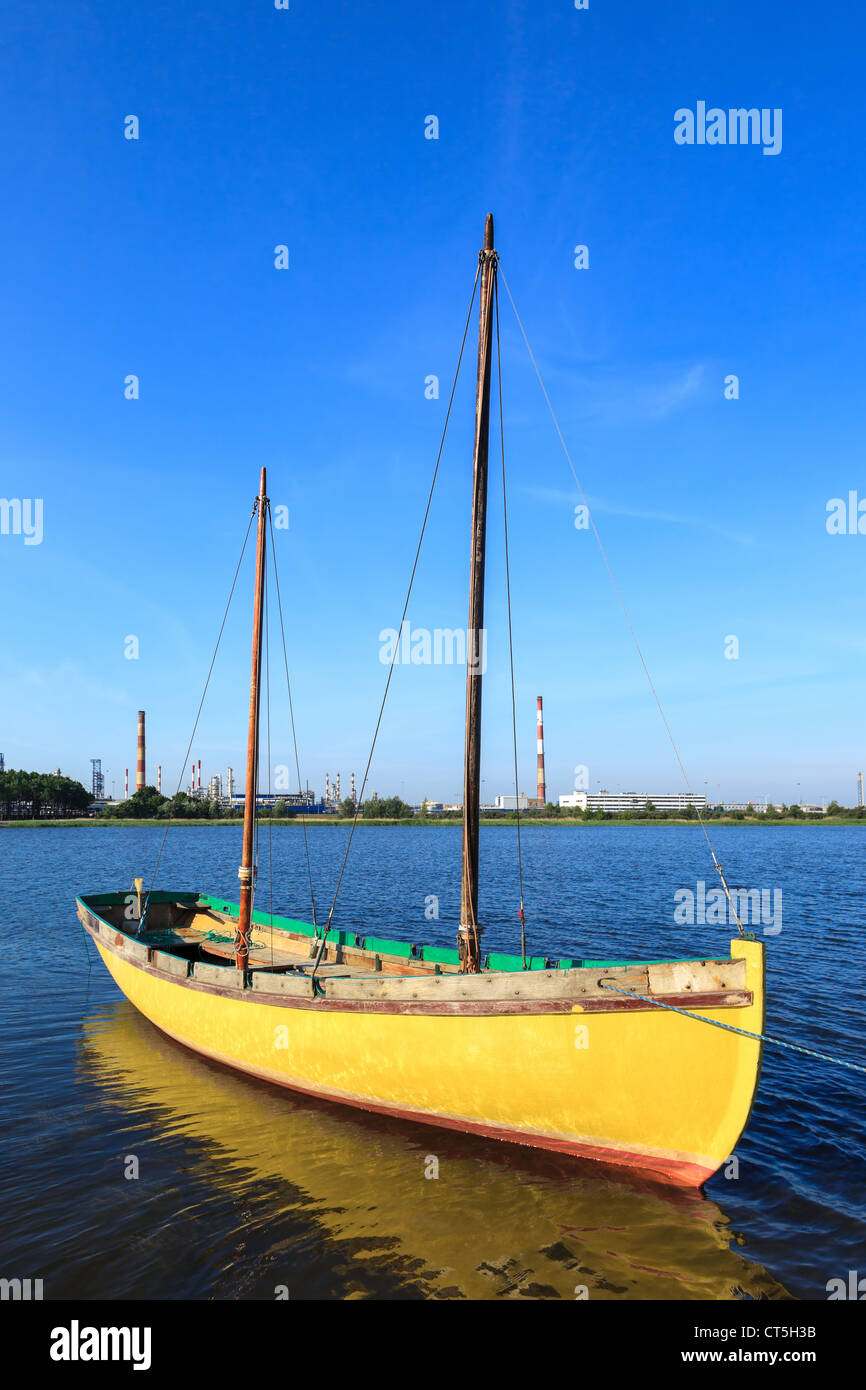 Old boat in the background of the refinery Stock Photo - Alamy