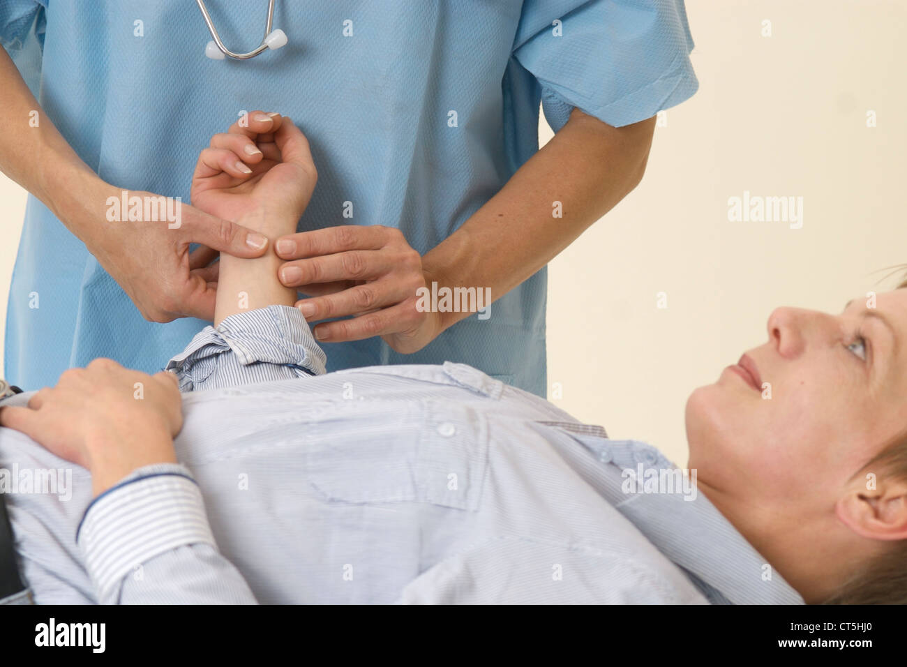 TAKING A WOMAN'S PULSE Stock Photo - Alamy