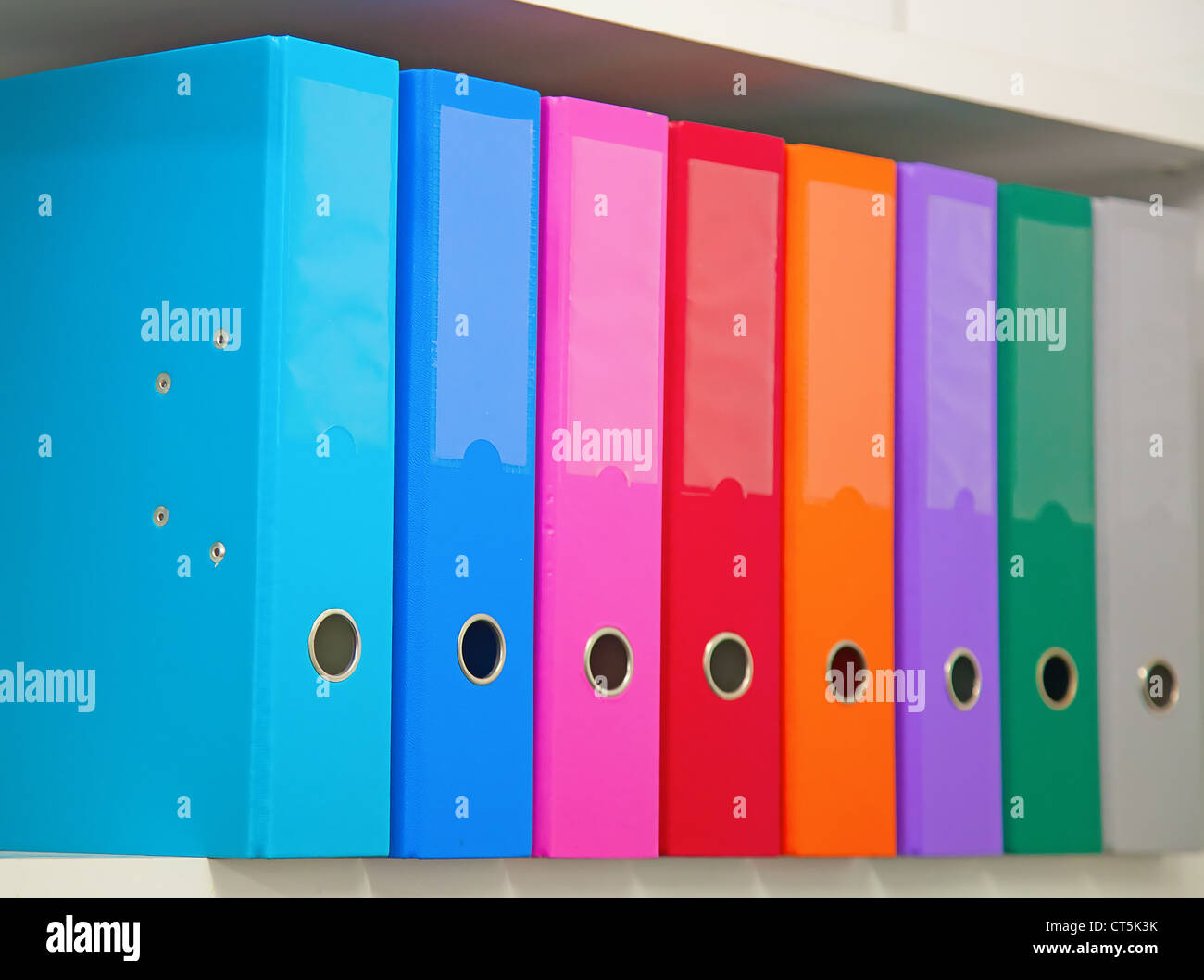 Colorful office folders on the bookshelf Stock Photo - Alamy