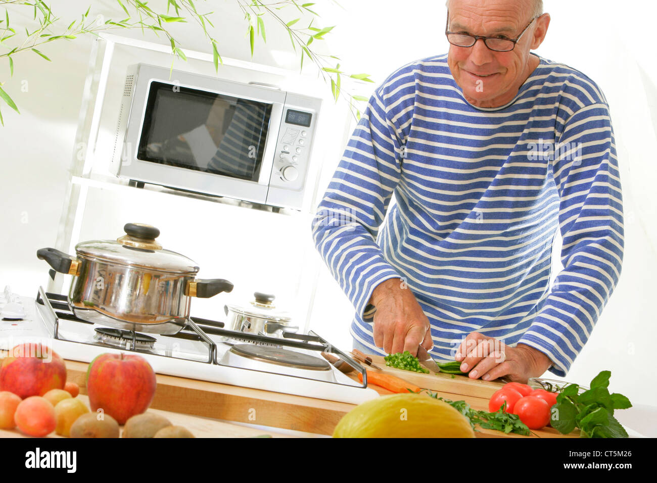 ELDERLY PERSON IN KITCHEN Stock Photo - Alamy