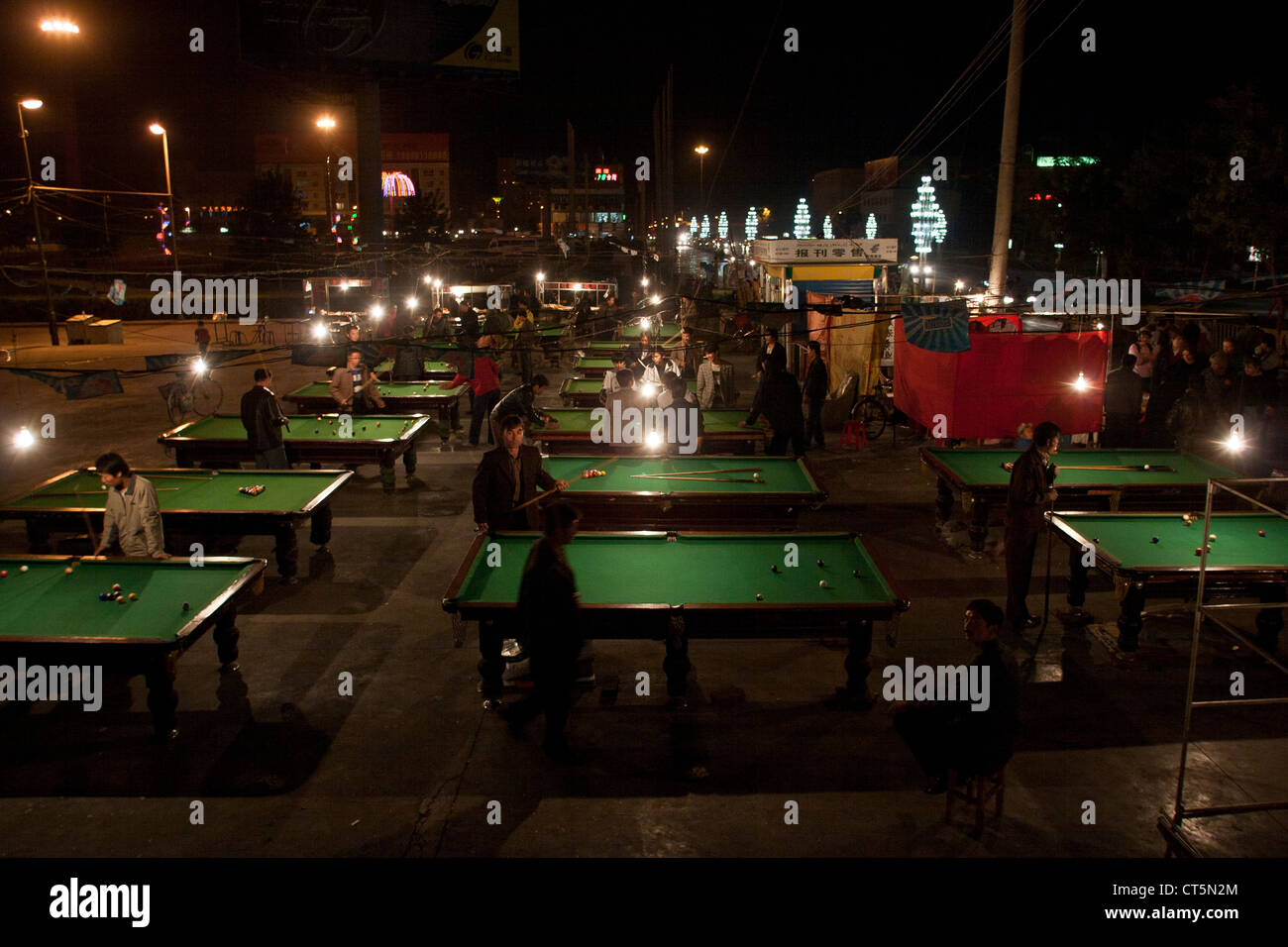 Men play pool outdoors during the evening in Turpan, Xinjiang, China ...
