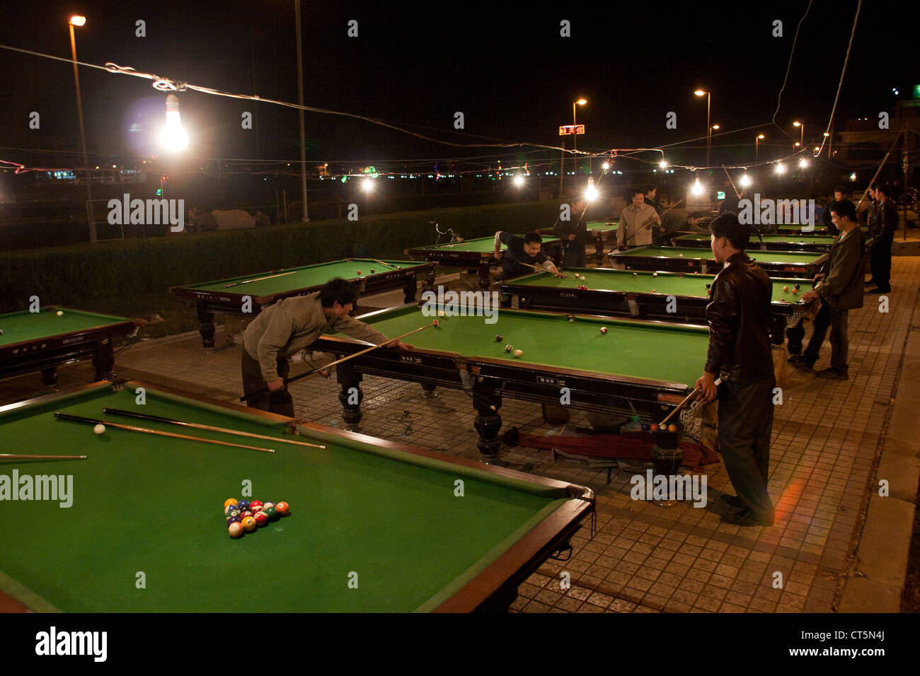 Men play pool outdoors during the evening in Turpan, Xinjiang, China ...