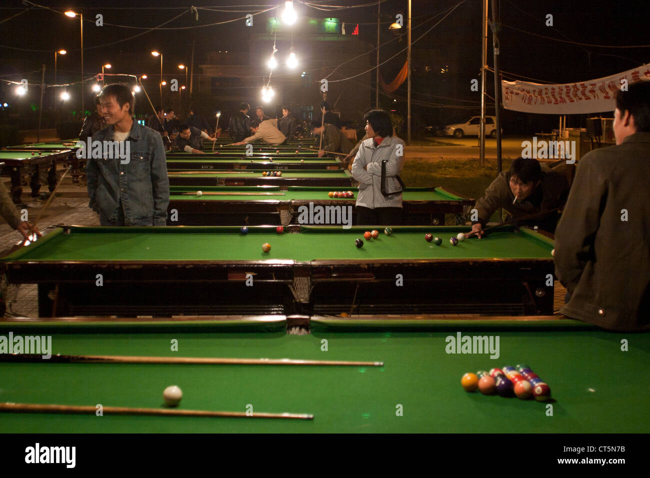 Men play pool outdoors during the evening in Turpan, Xinjiang, China ...