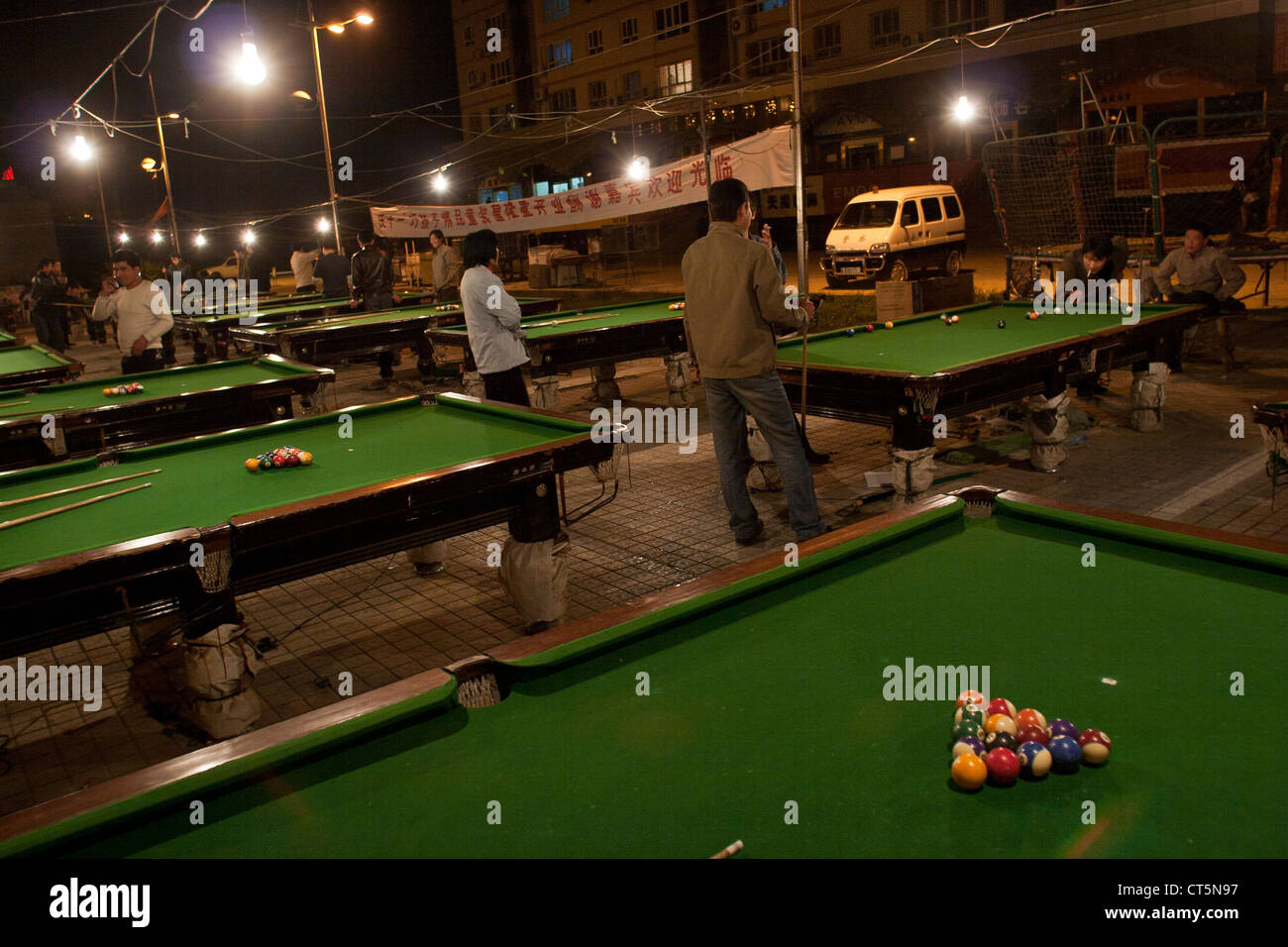 Men play pool outdoors during the evening in Turpan, Xinjiang, China ...