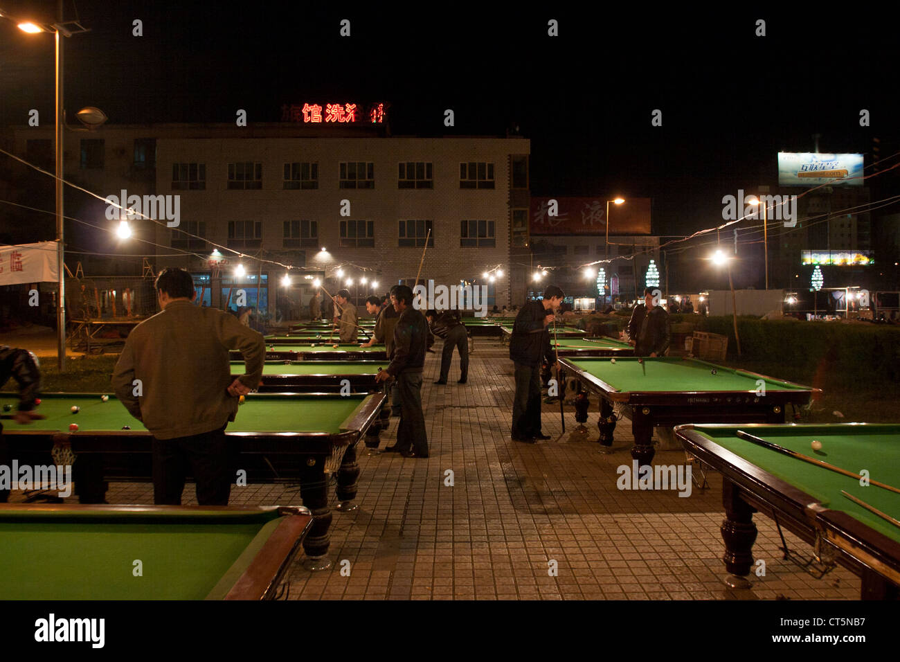 Men play pool outdoors during the evening in Turpan, Xinjiang, China ...