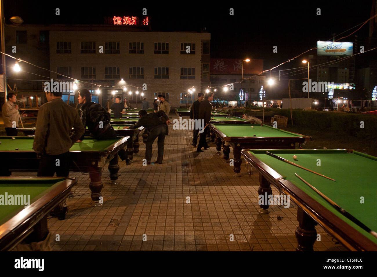 Men play pool outdoors during the evening in Turpan, Xinjiang, China ...