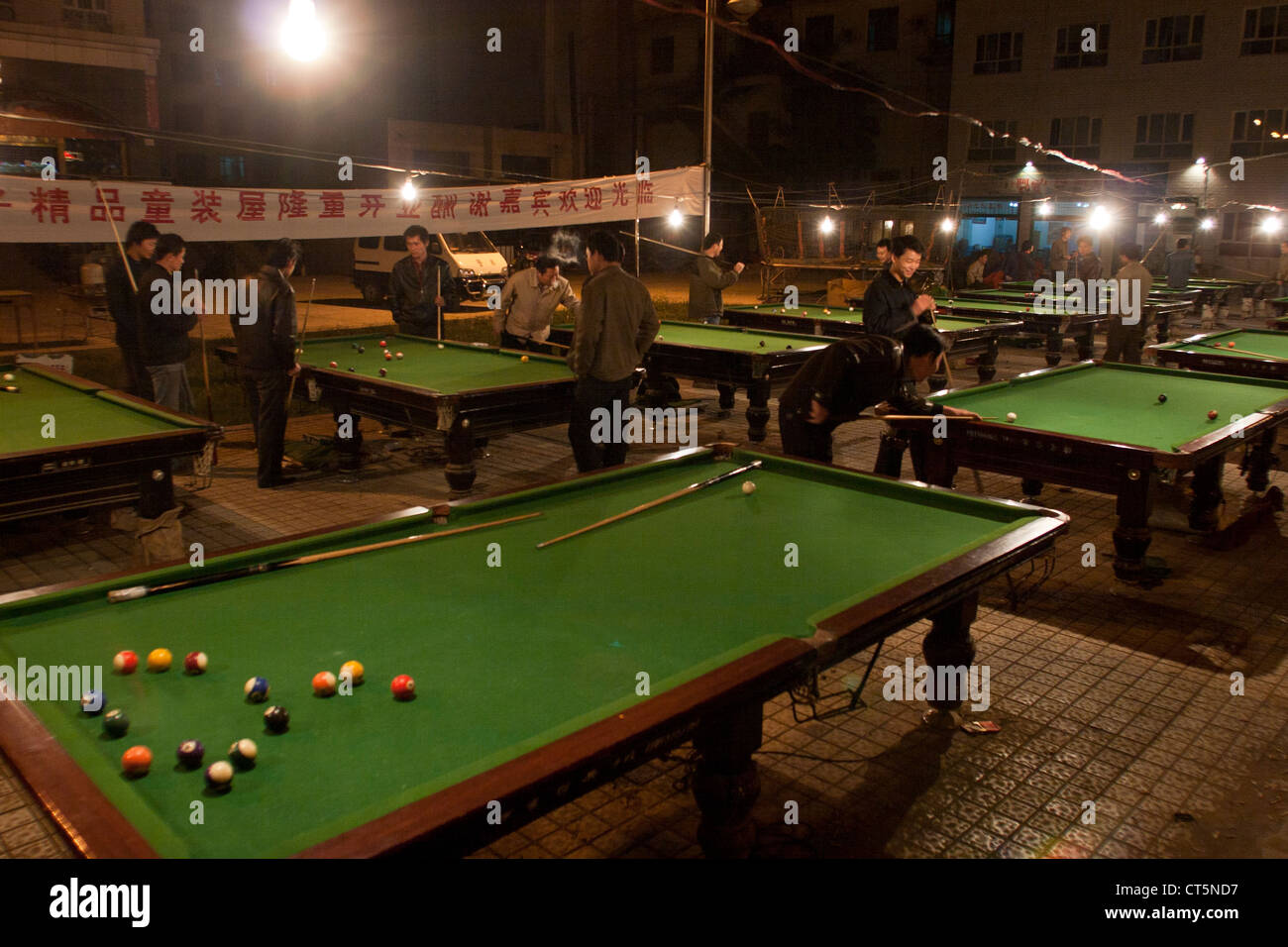 Men play pool outdoors during the evening in Turpan, Xinjiang, China ...