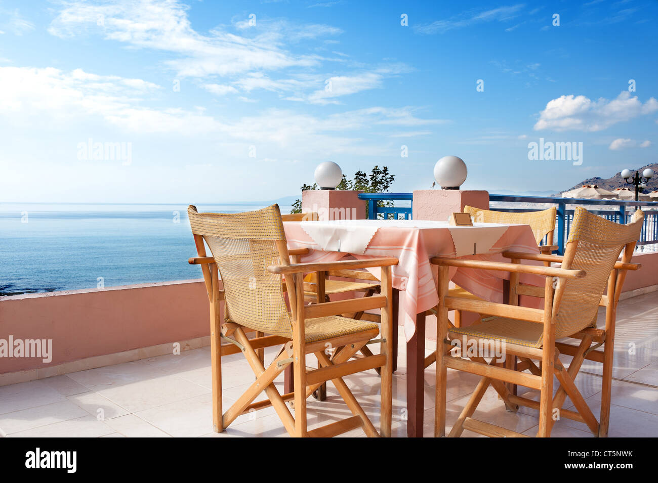 A restaurant table and chairs overlooking the sea Stock Photo - Alamy