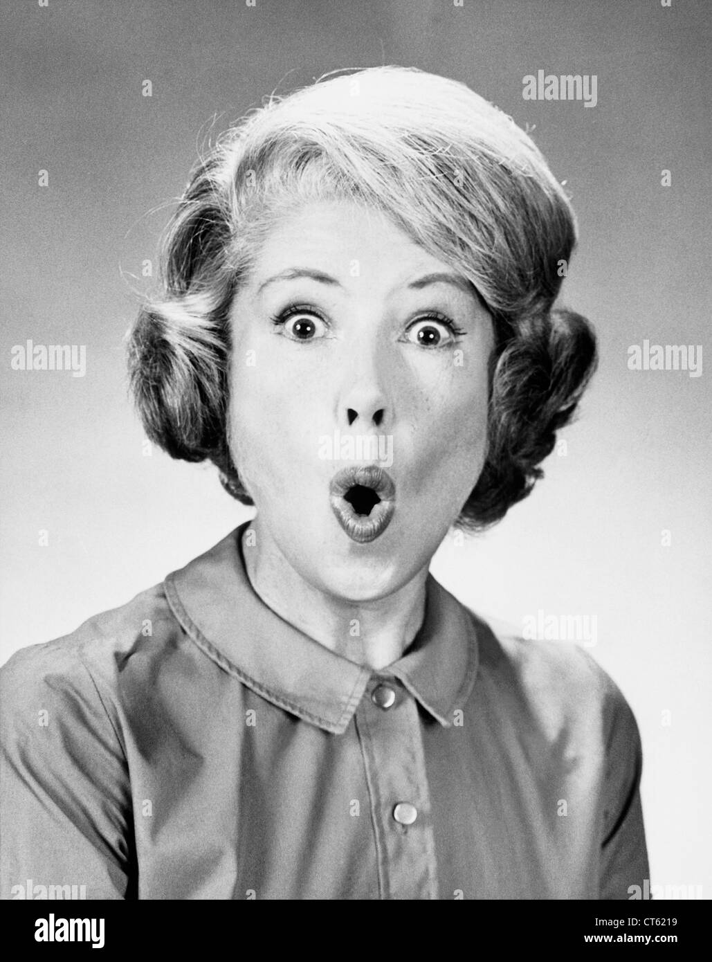 Portrait of woman with look of surprise Stock Photo - Alamy