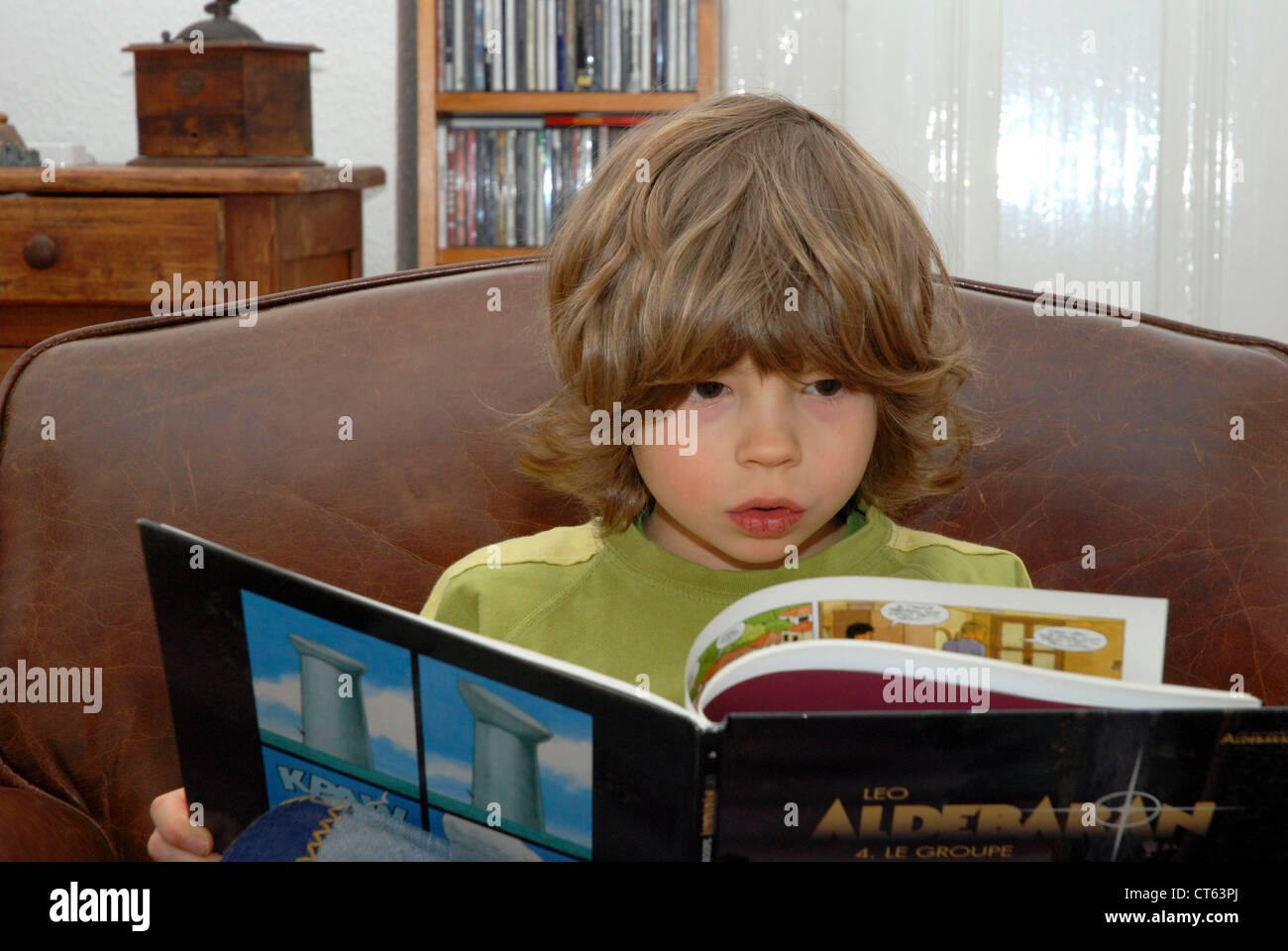 CHILD READING INDOORS Stock Photo - Alamy