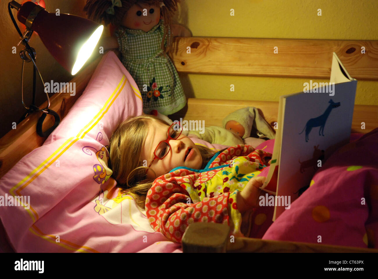 CHILD READING INDOORS Stock Photo - Alamy