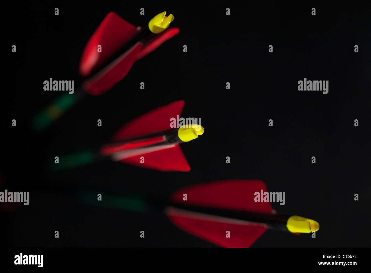 Three archery arrows in a tight group Stock Photo - Alamy
