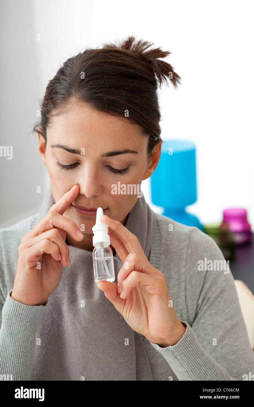 WOMAN USING NOSE SPRAY Stock Photo - Alamy
