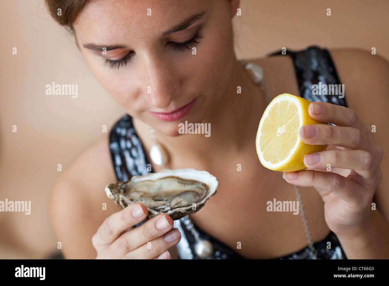 Woman eating sellfish hi-res stock photography and images - Alamy