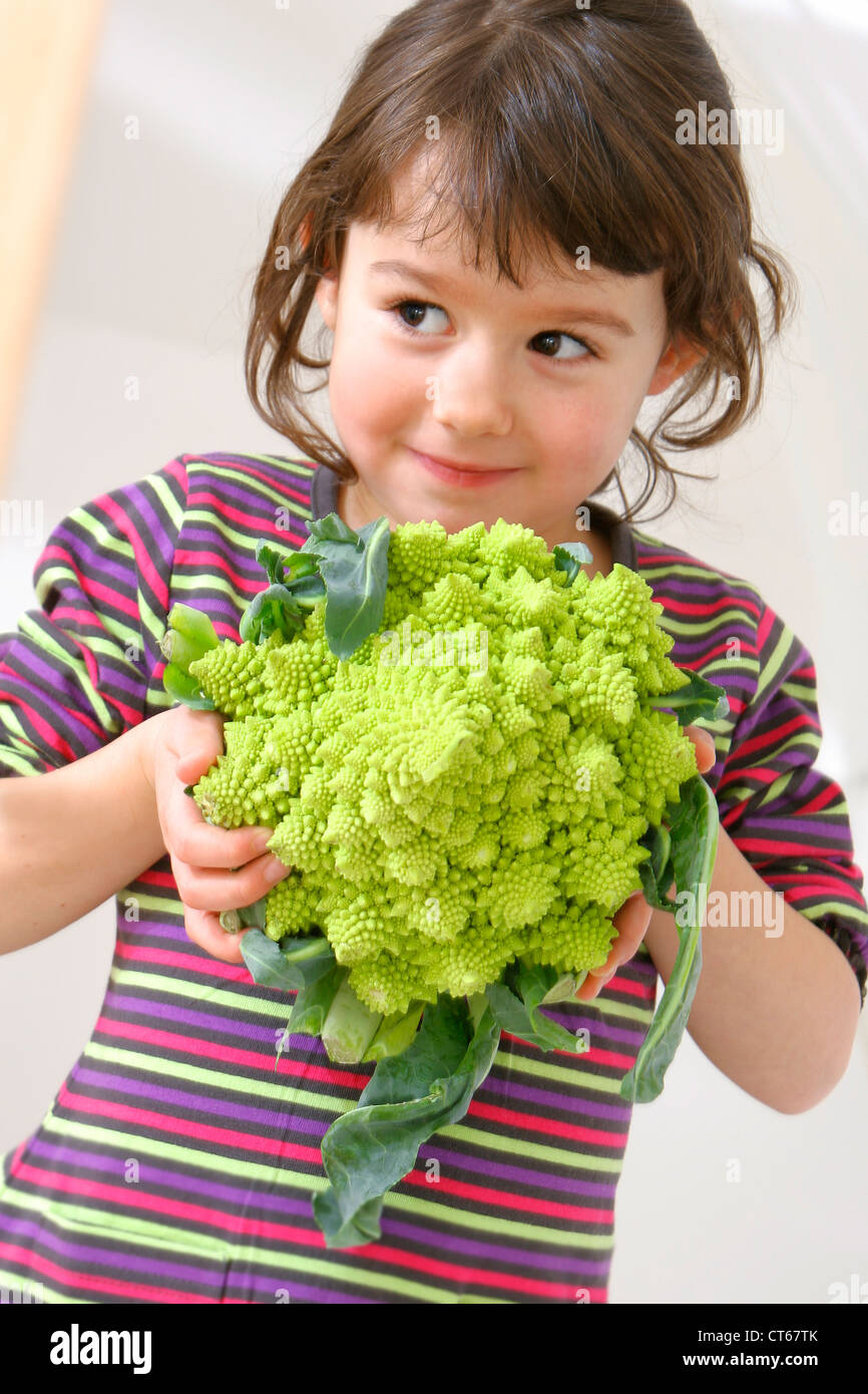 CHILD EATING VEGETABLE Stock Photo - Alamy